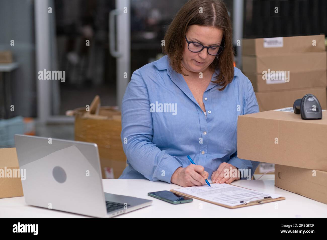 online store woman using laptop packing order express delivery ...