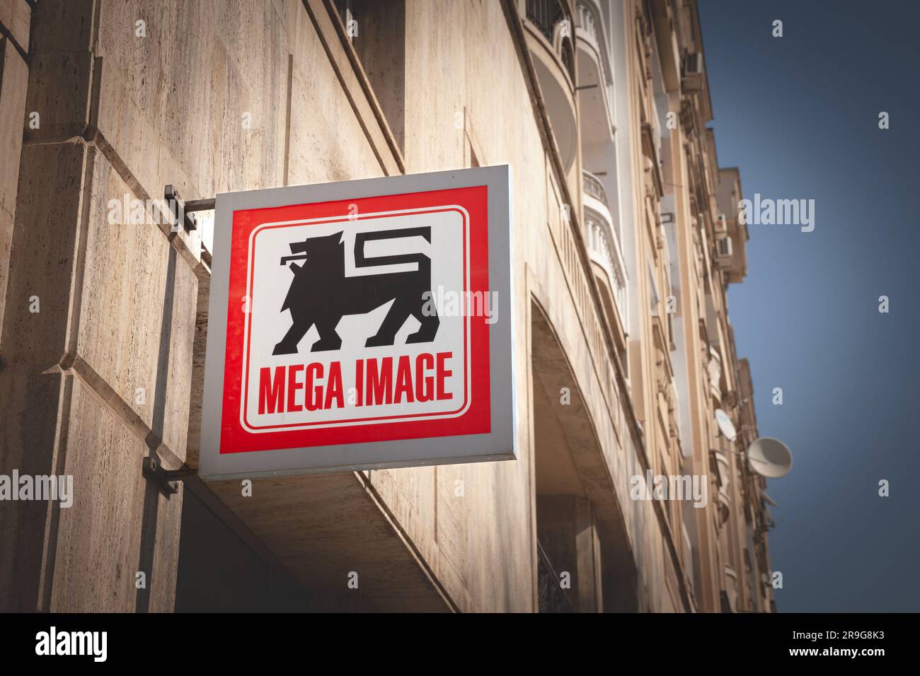 Picture of a sign with the logo of Mega Image in the city center of ...
