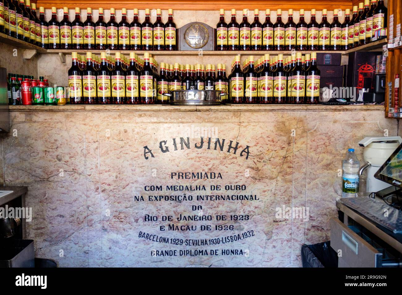 Ginjinha sour cherry liqueur bottles on shelf, inside A Ginginha Bar ...