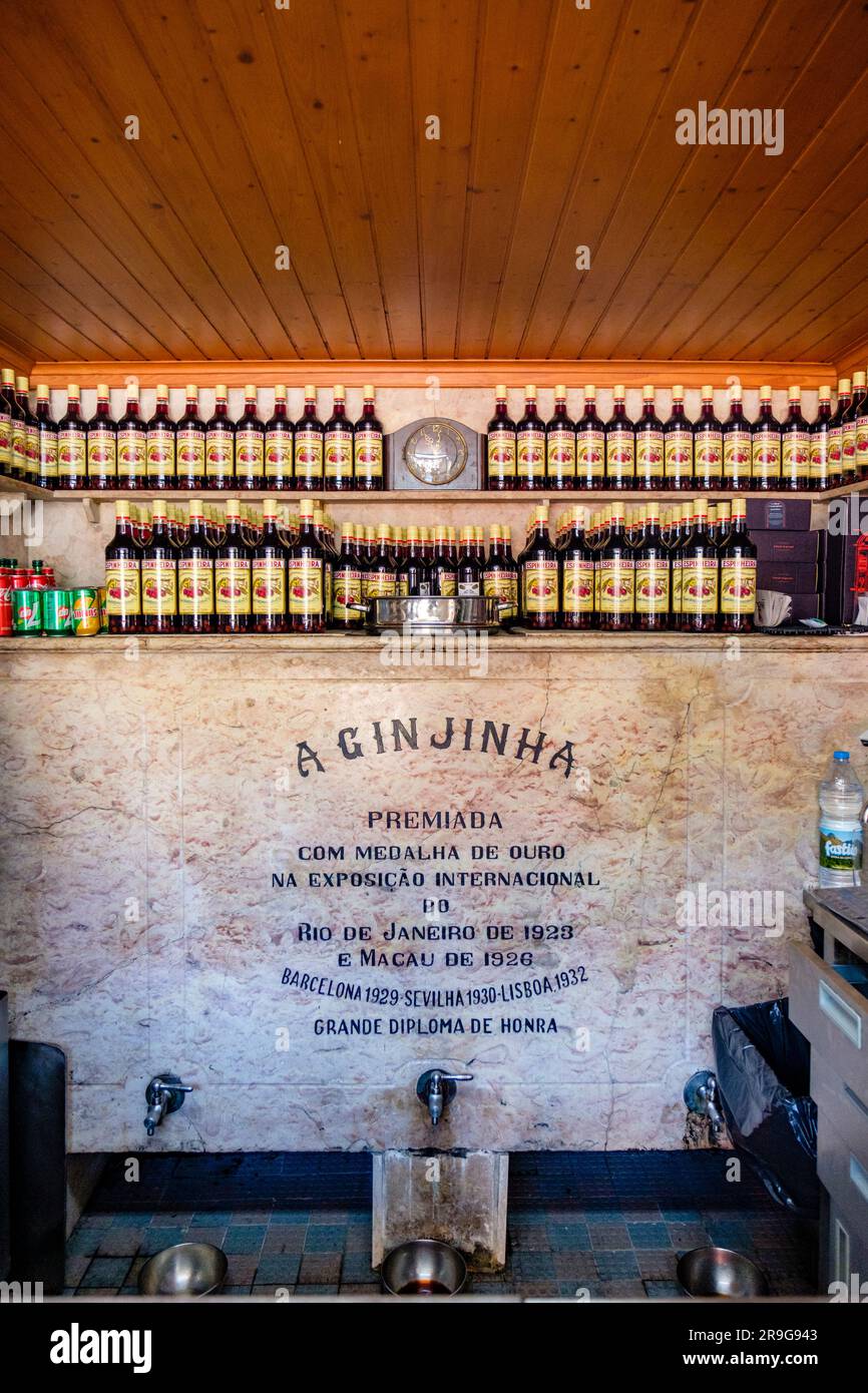Ginjinha sour cherry liqueur bottles on shelf, inside A Ginginha Bar ...