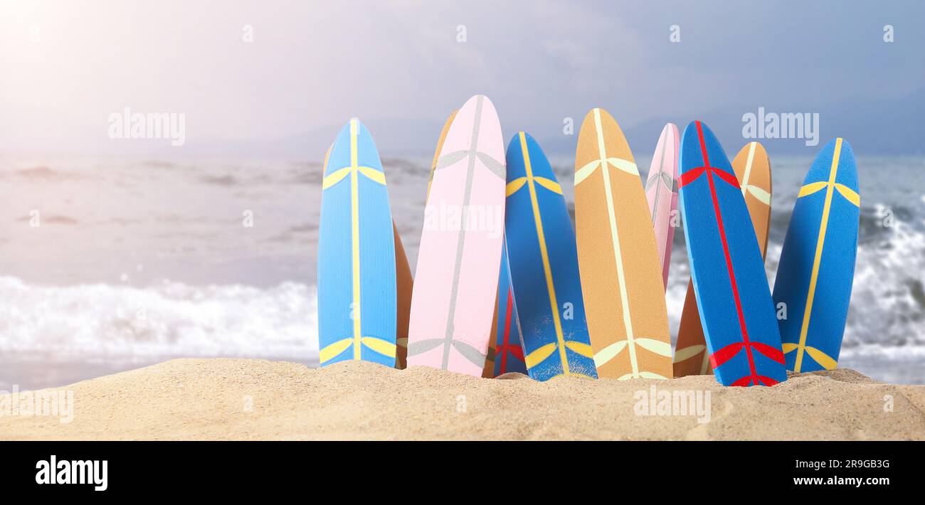 Many small surfboards on beach sand Stock Photo - Alamy