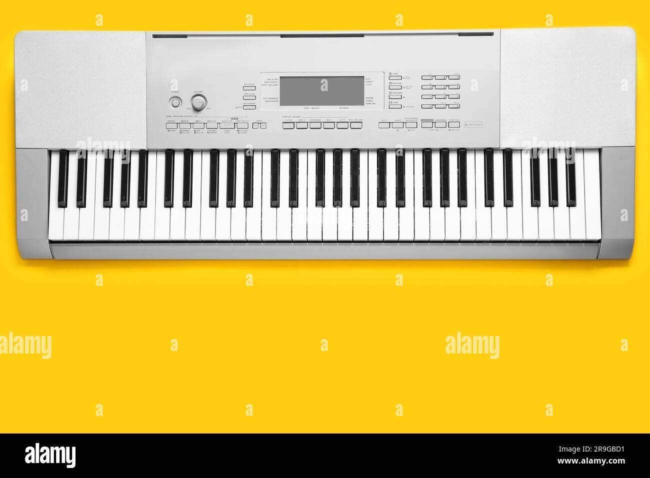 Modern synthesizer keyboard on yellow background Stock Photo - Alamy