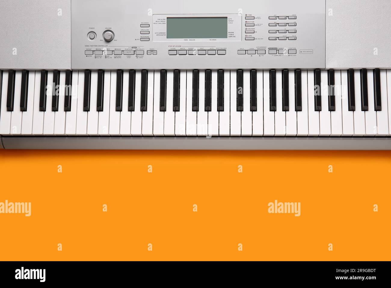 Modern synthesizer keyboard on orange background Stock Photo - Alamy