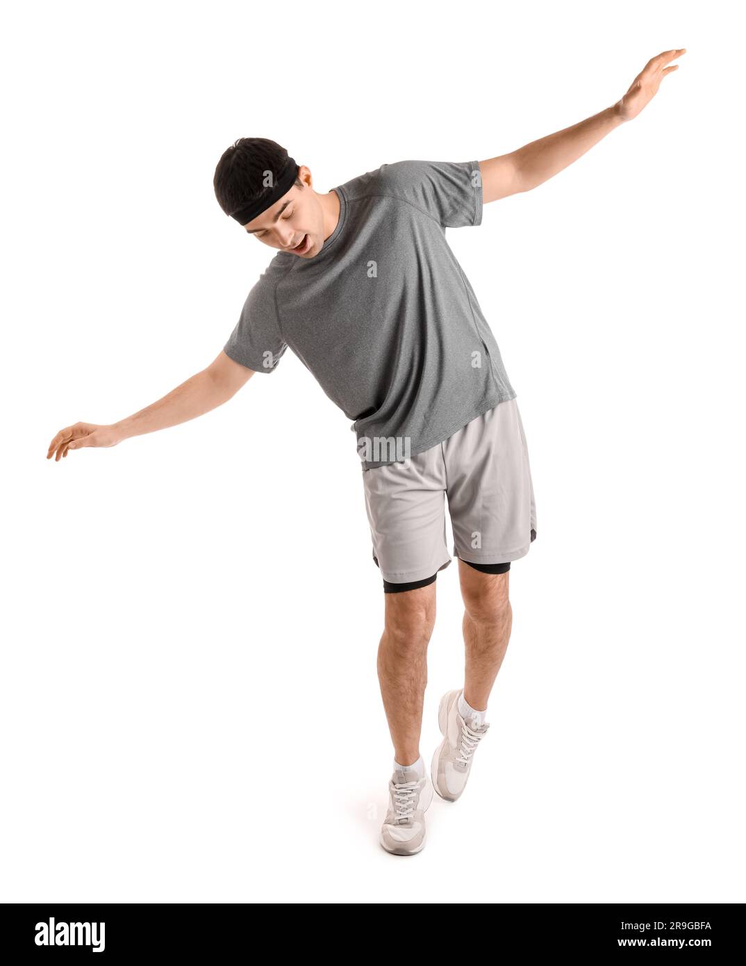 Sporty young man balancing on white background Stock Photo - Alamy Sporty young man balancing on white background Stock Photo - Alamy
