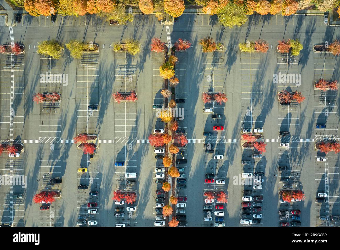 Aerial view of many colorful cars parked on parking lot with lines and ...