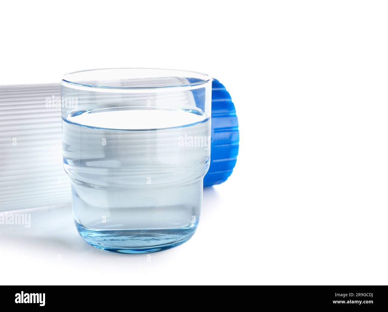 Glass of liquid and water filter cartridge isolated on white background ...