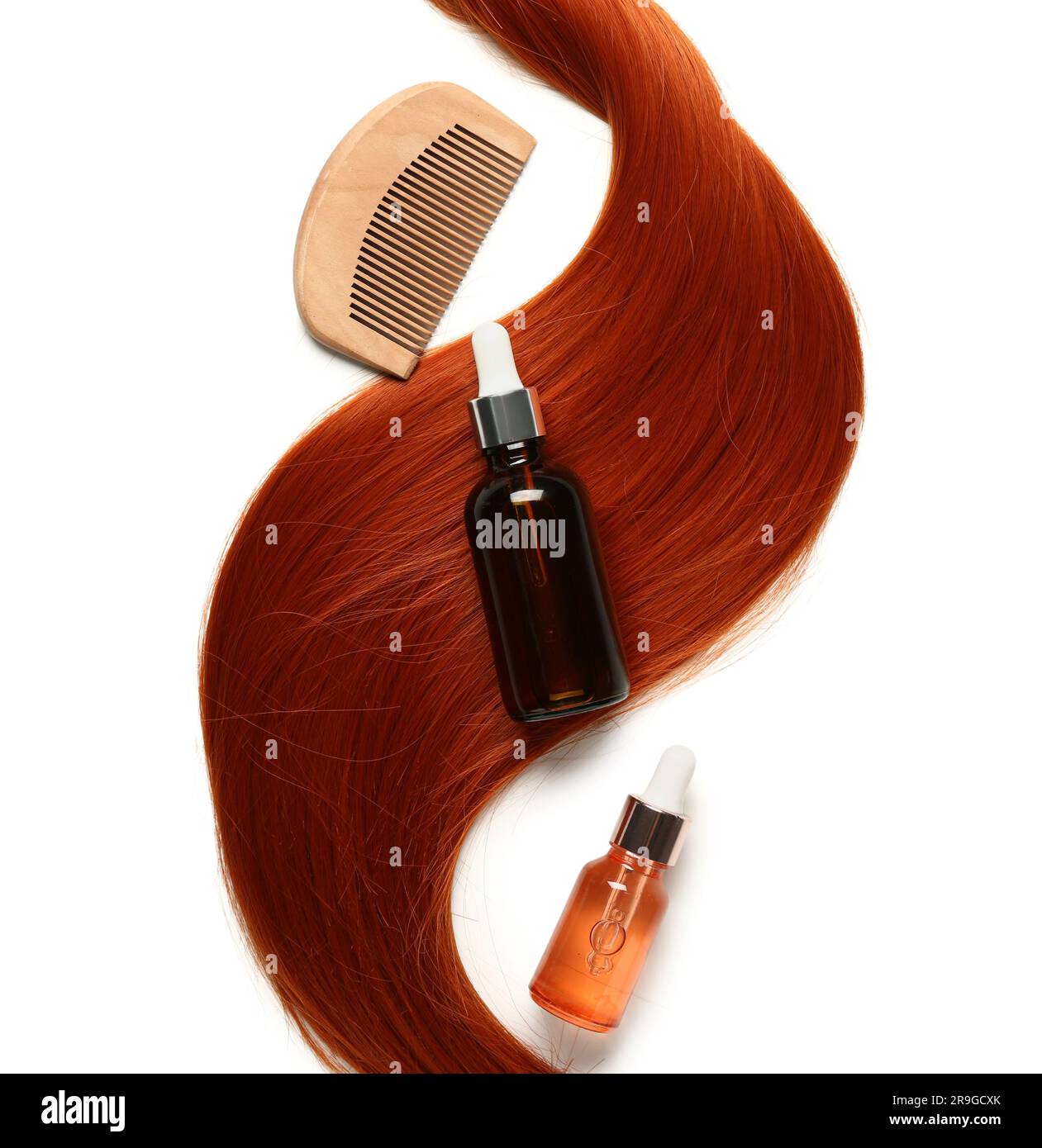 Ginger hair strand, comb and bottles of cosmetic products on white ...