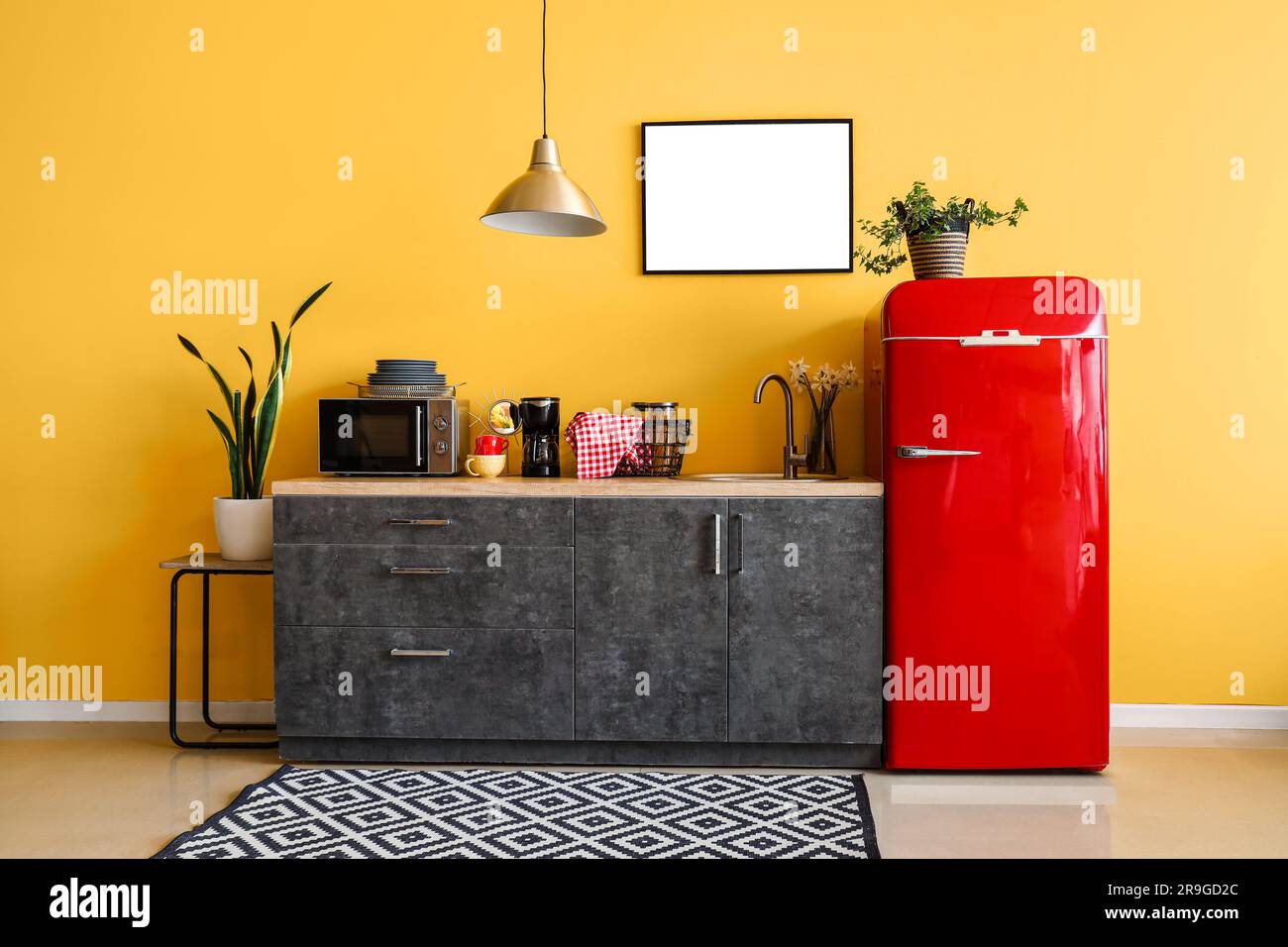 Interior of stylish kitchen with red fridge, counters, blank picture ...