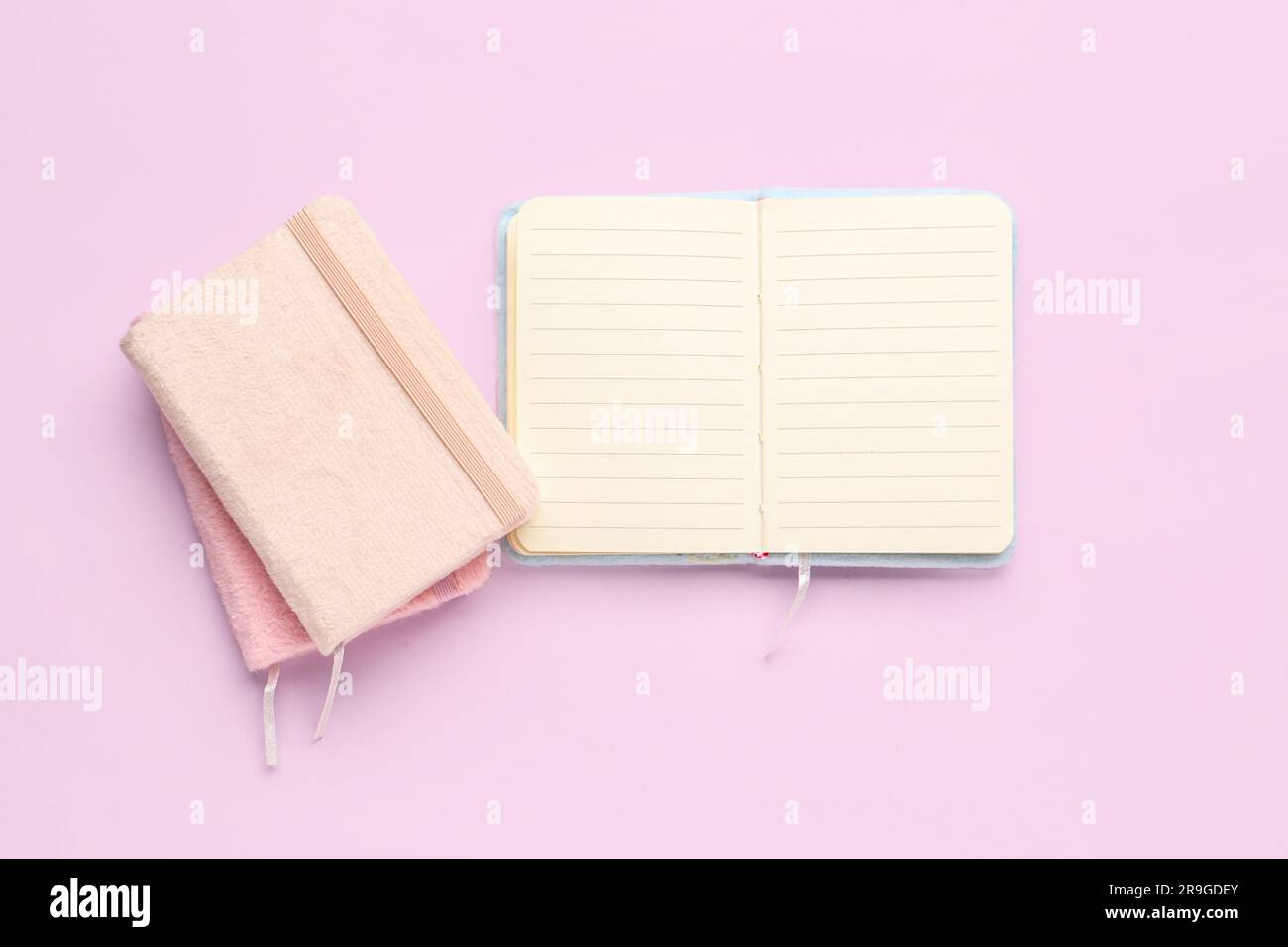 Set of notebooks on pink background Stock Photo - Alamy