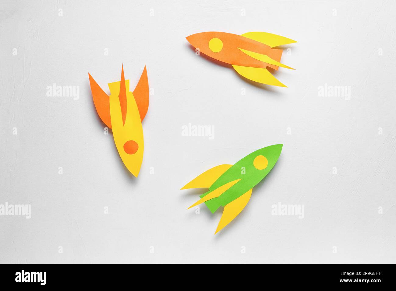 Color paper rockets on white background Stock Photo - Alamy