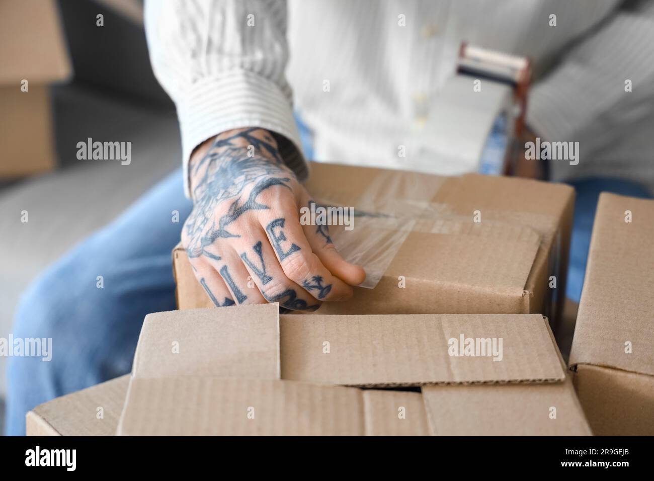 Caucasian man taping cardboard box hi-res stock photography and images ...