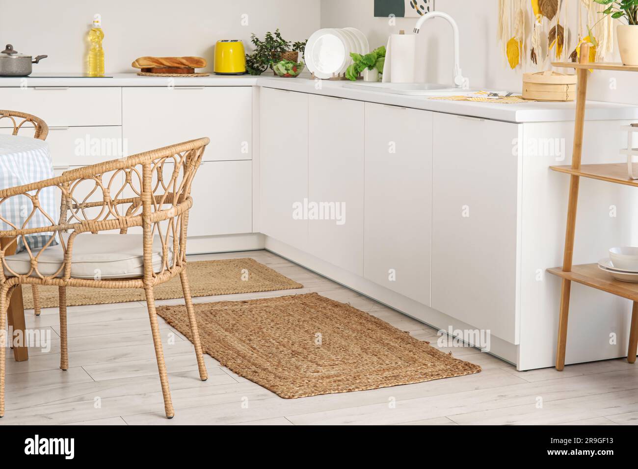 Stylish wicker rugs in interior of modern kitchen Stock Photo - Alamy