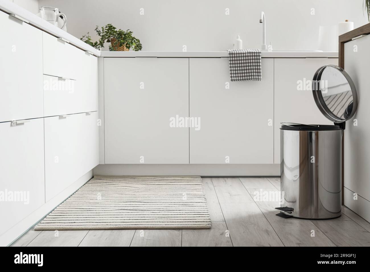 Opened trash bin in interior of light kitchen Stock Photo - Alamy