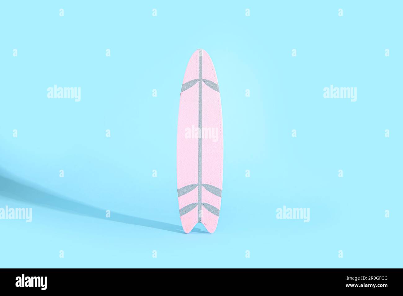 Mini surfboard on blue background Stock Photo - Alamy