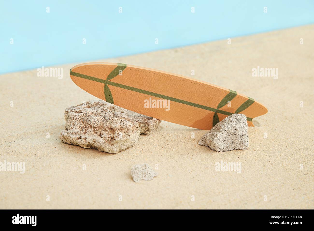 Mini surfboard with stones on sand against blue background Stock Photo ...