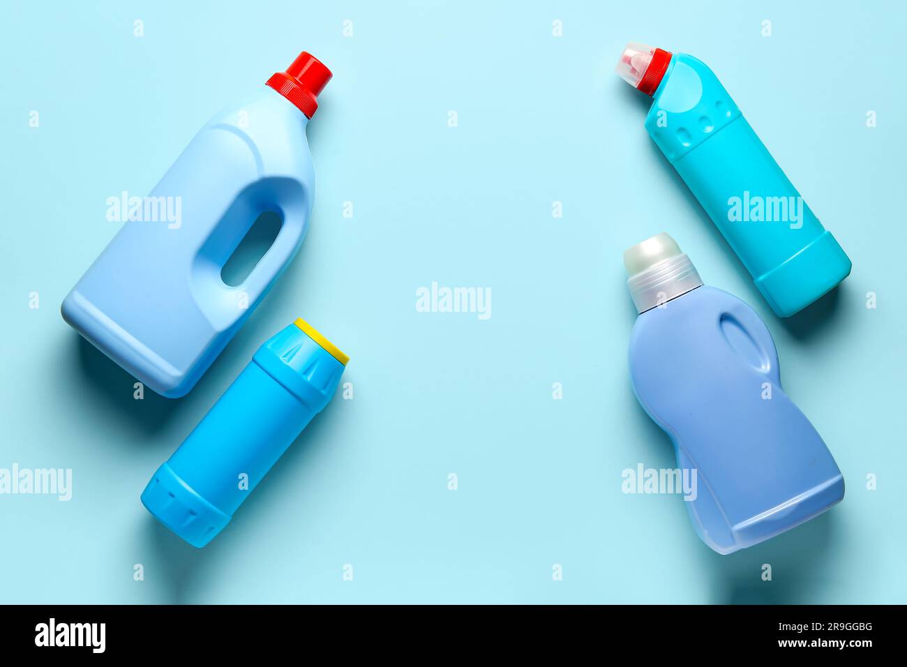 Bottles of detergent on blue background Stock Photo - Alamy