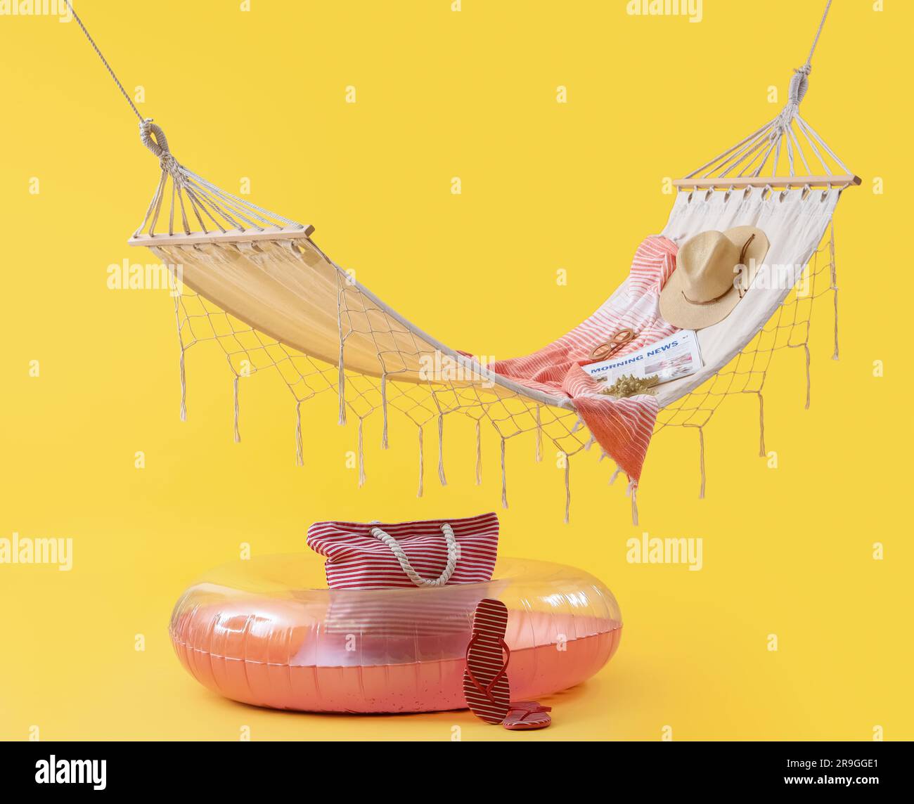 Cozy hammock with inflatable ring and different beach accessories on ...
