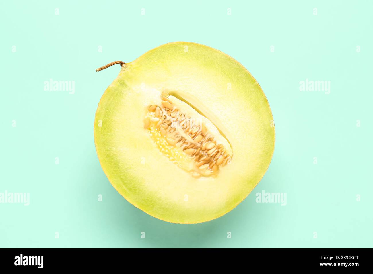 Half of sweet melon on turquoise background Stock Photo - Alamy