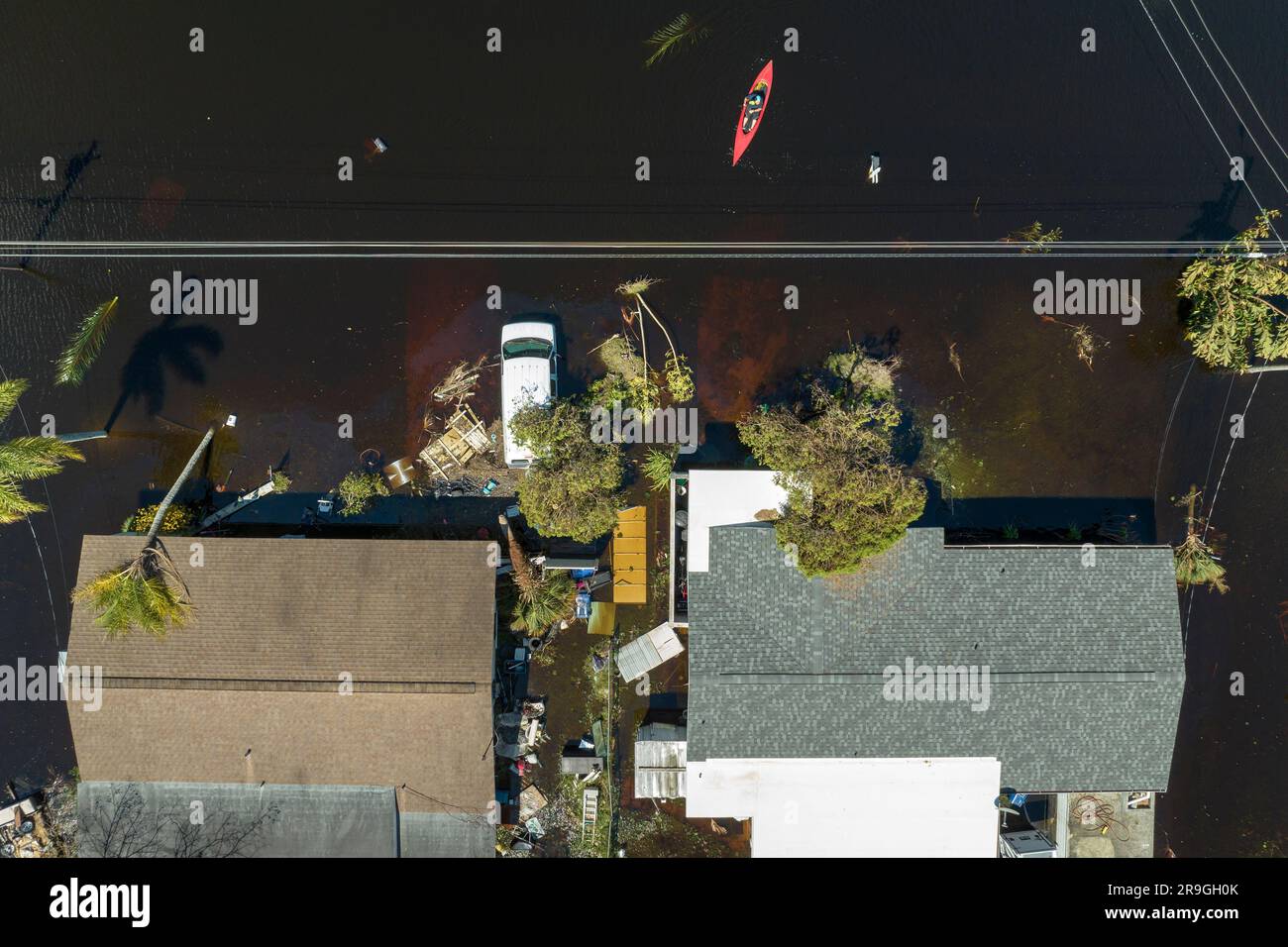 Kayak boat floating on flooded street surrounded by hurricane Ian ...