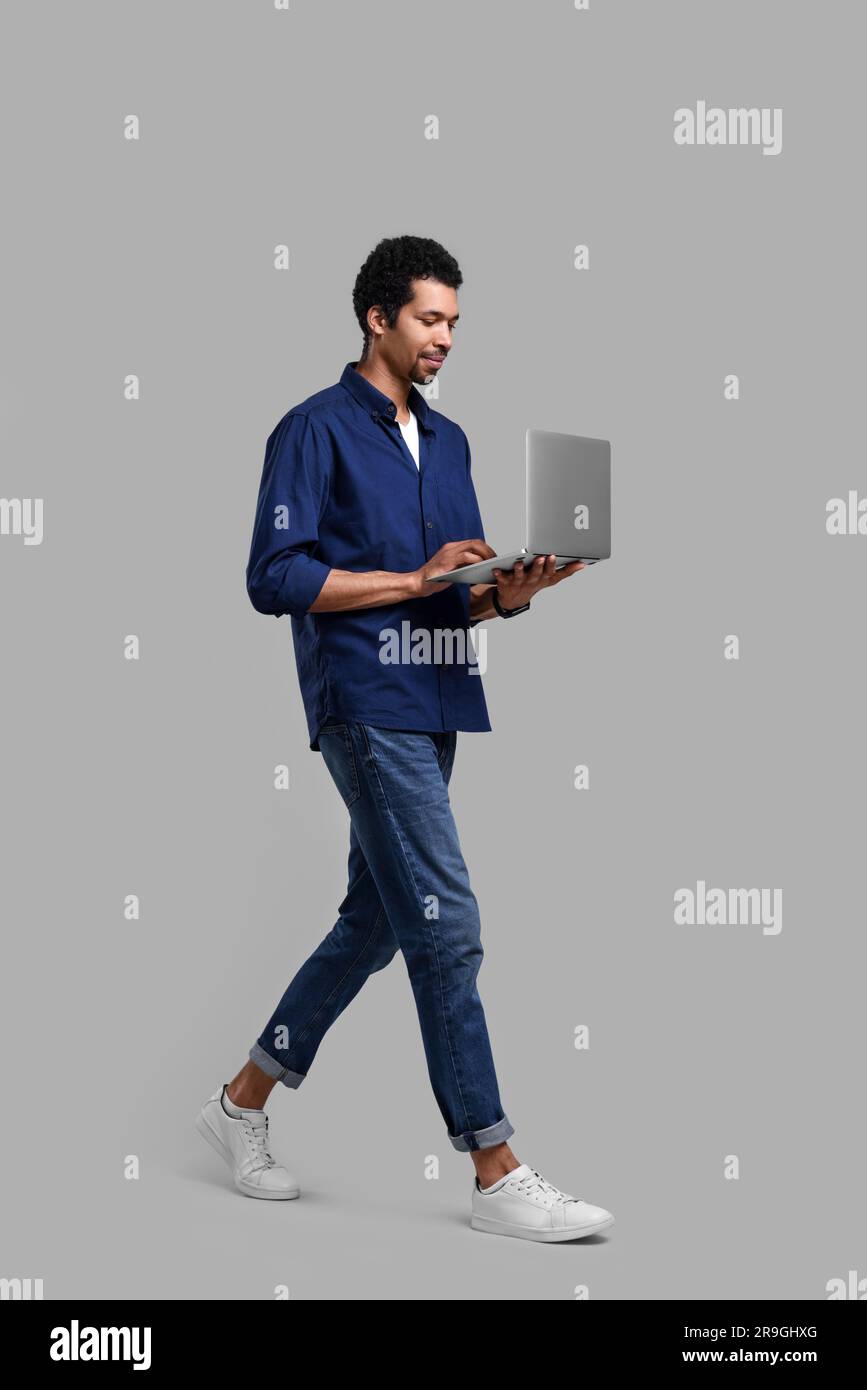 Professional man walking laptop computer hi-res stock photography and ...