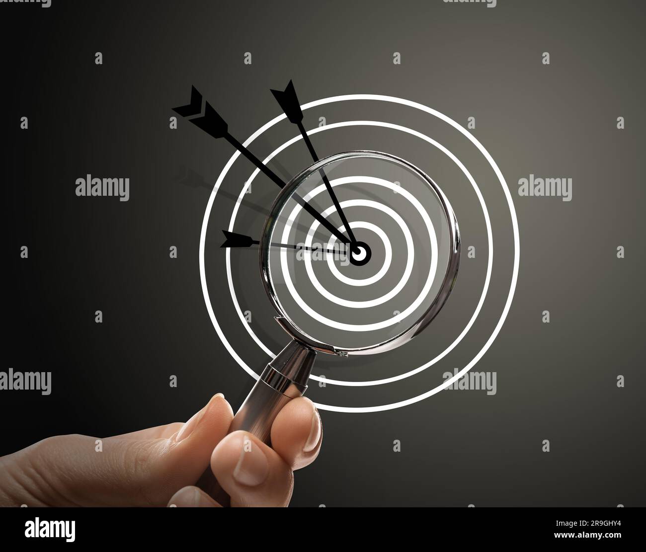 Woman holding magnifying glass on dark background, closeup ...
