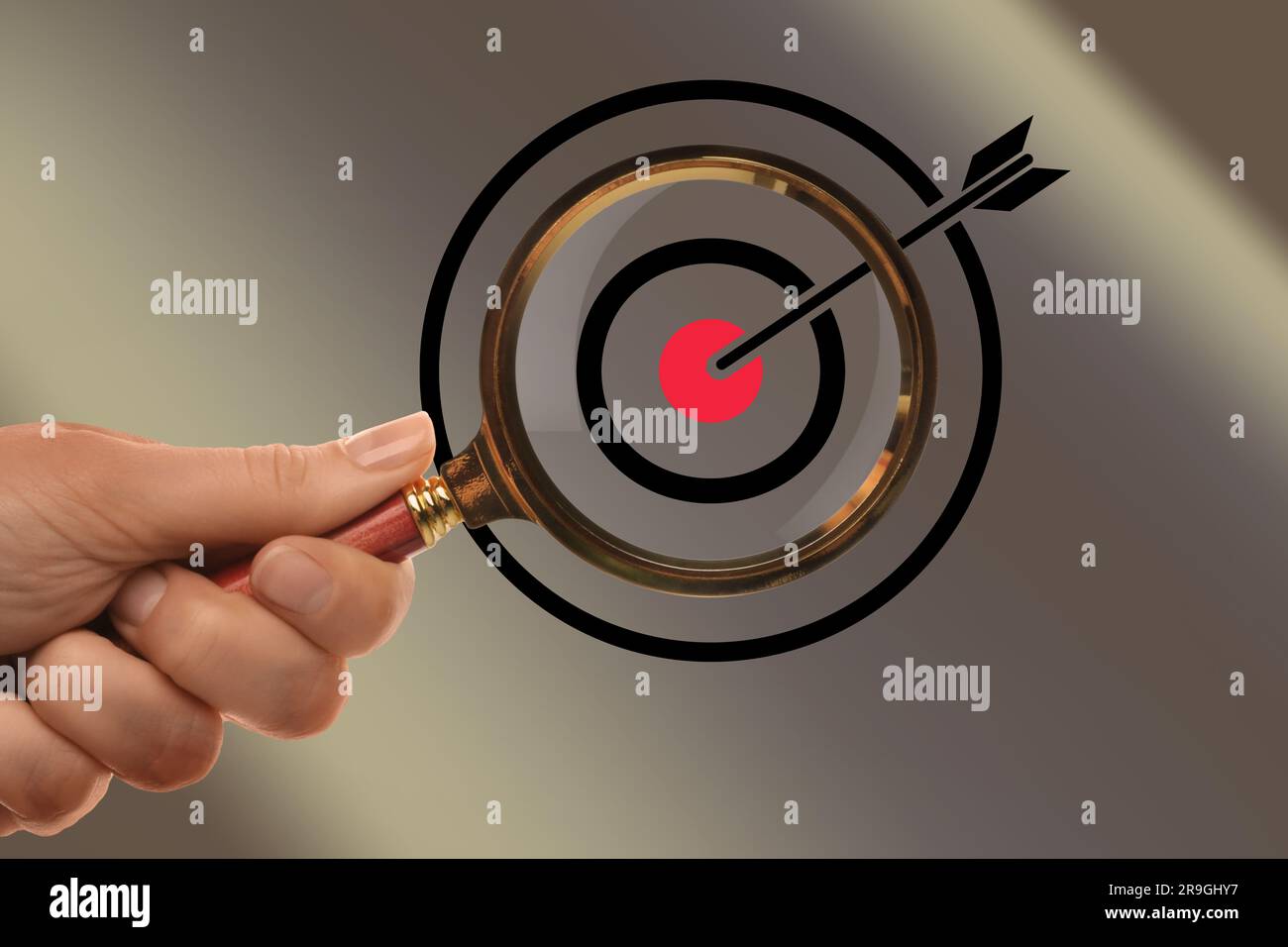 Woman holding magnifying glass on grey gradient background, closeup ...