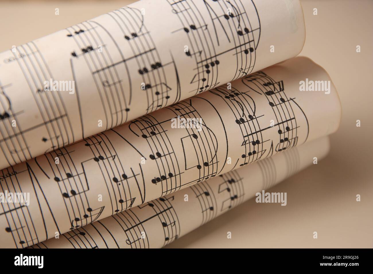 Rolled sheets with music notes on light background, closeup Stock Photo ...
