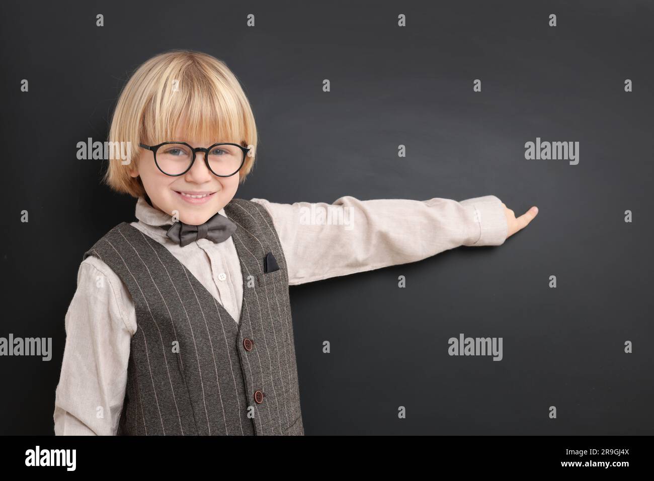 Happy little school child pointing at chalkboard Stock Photo - Alamy