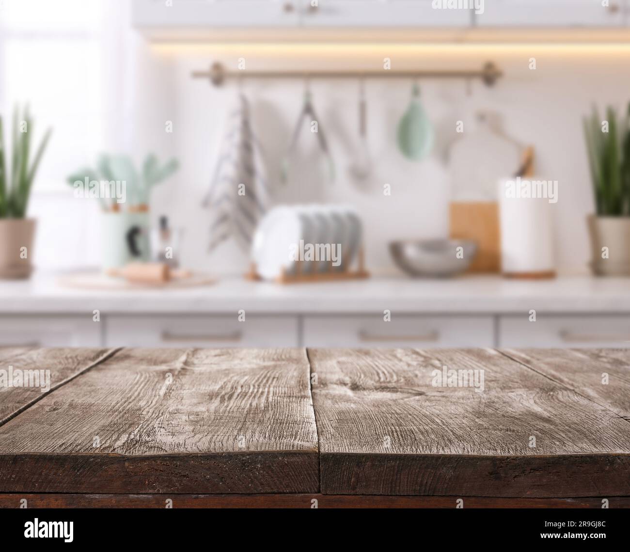 Empty wooden table in beautiful kitchen. Space for design Stock Photo ...