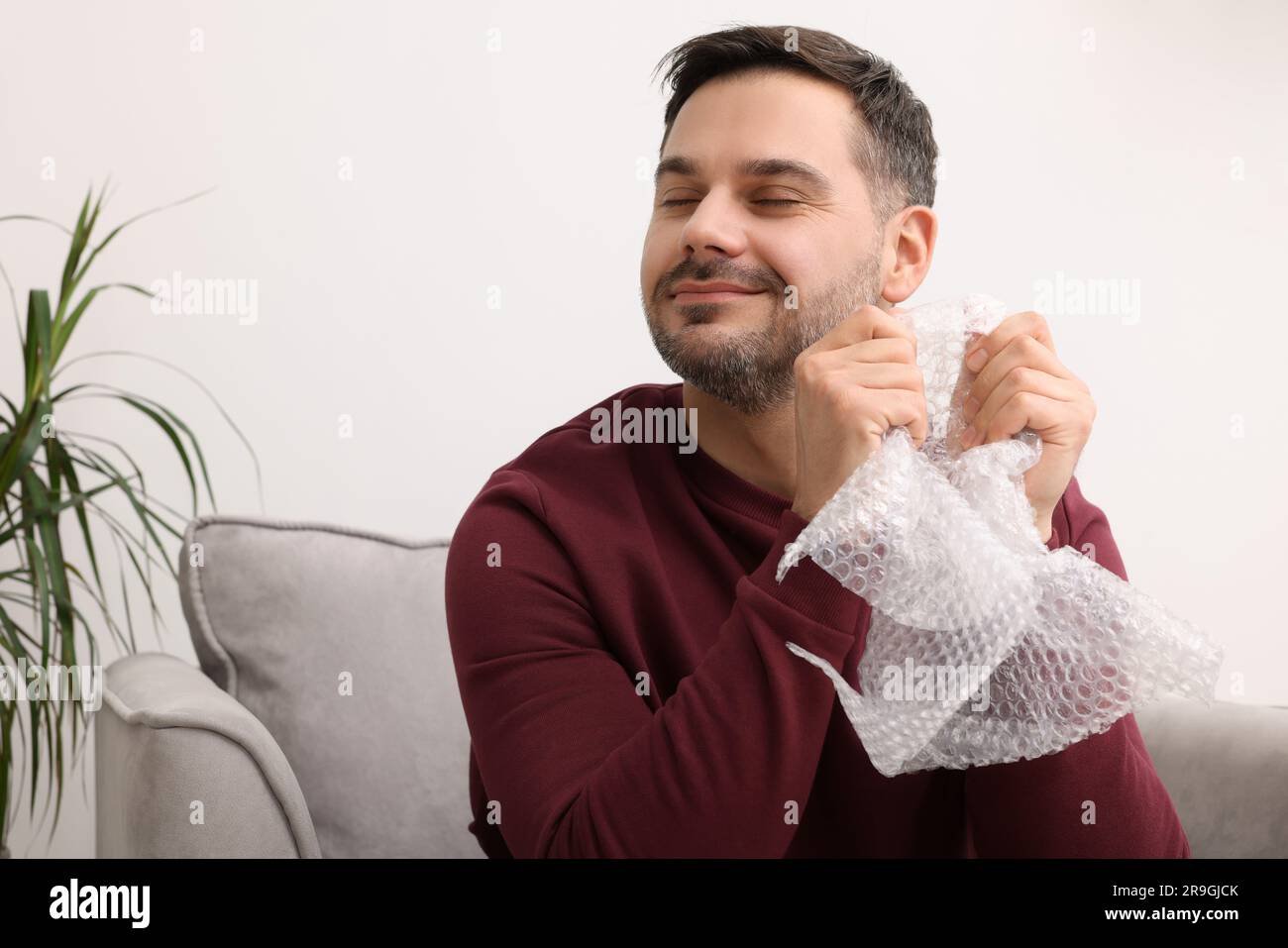 Happy man popping bubble hi-res stock photography and images - Alamy