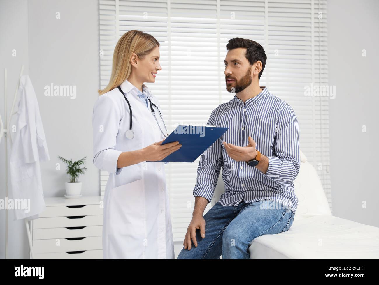 Patient having appointment with doctor in clinic Stock Photo - Alamy