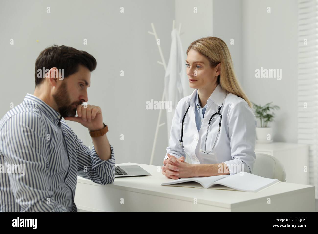 Patient having appointment with doctor in clinic Stock Photo - Alamy