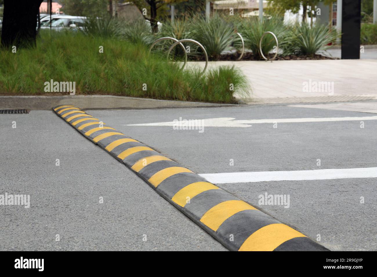 Striped speed bump on street. Road safety Stock Photo - Alamy