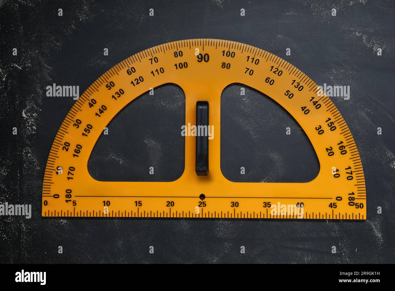 Protractor with measuring length and degree markings on blackboard, top ...