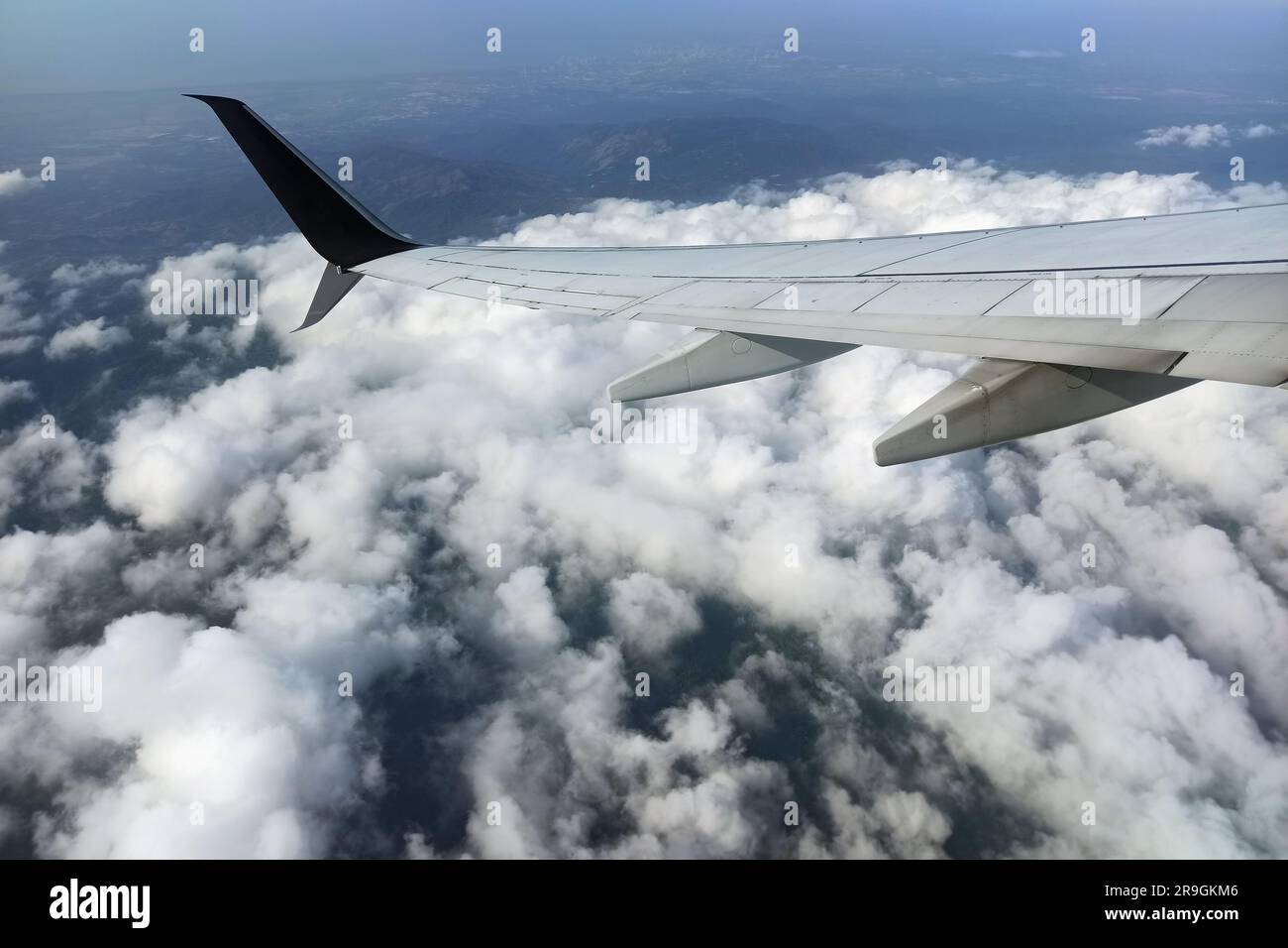 View through airplane window of commercial jet plane wing flying high ...
