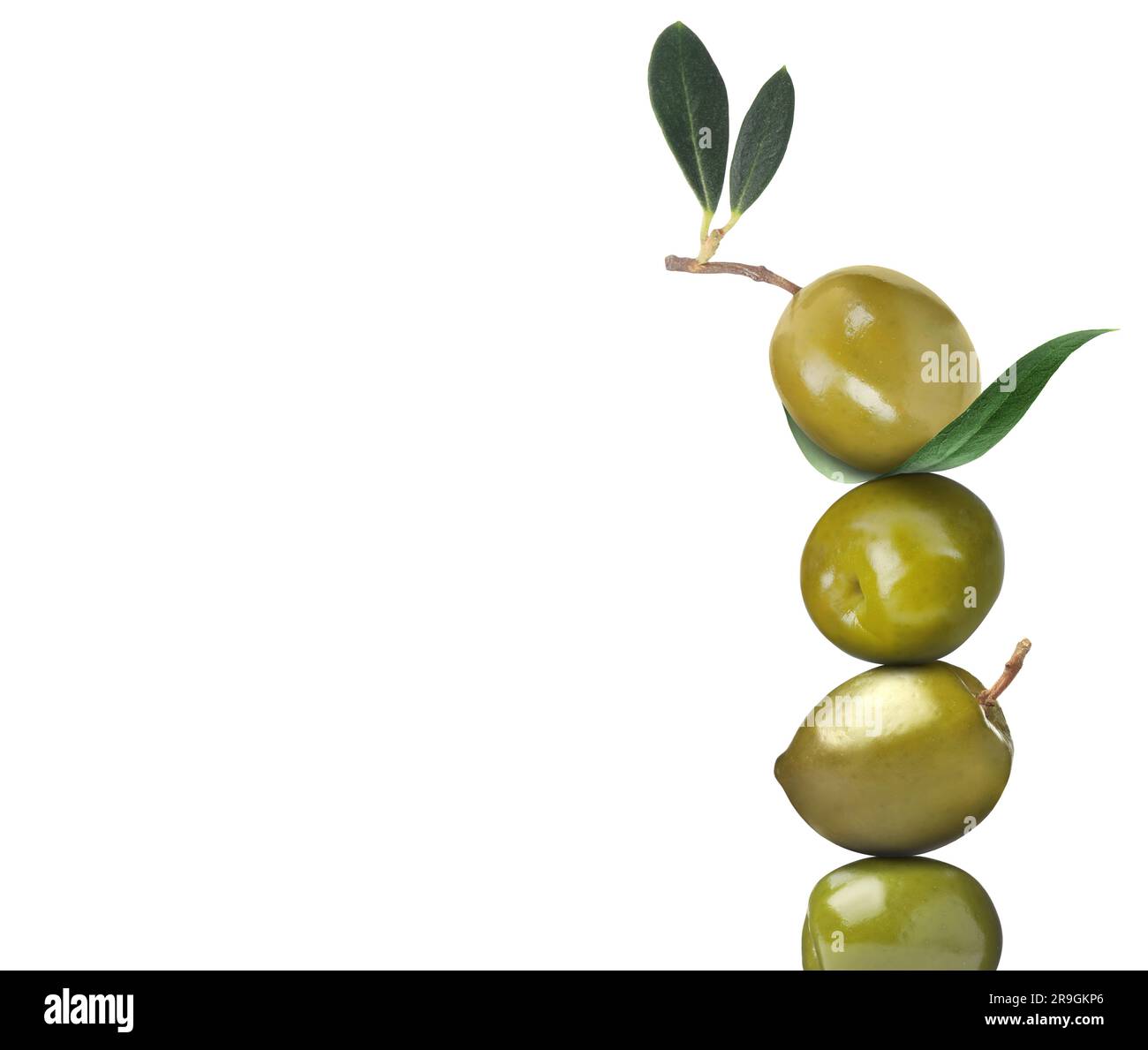Stack of whole green olives with leaves on white background Stock Photo ...