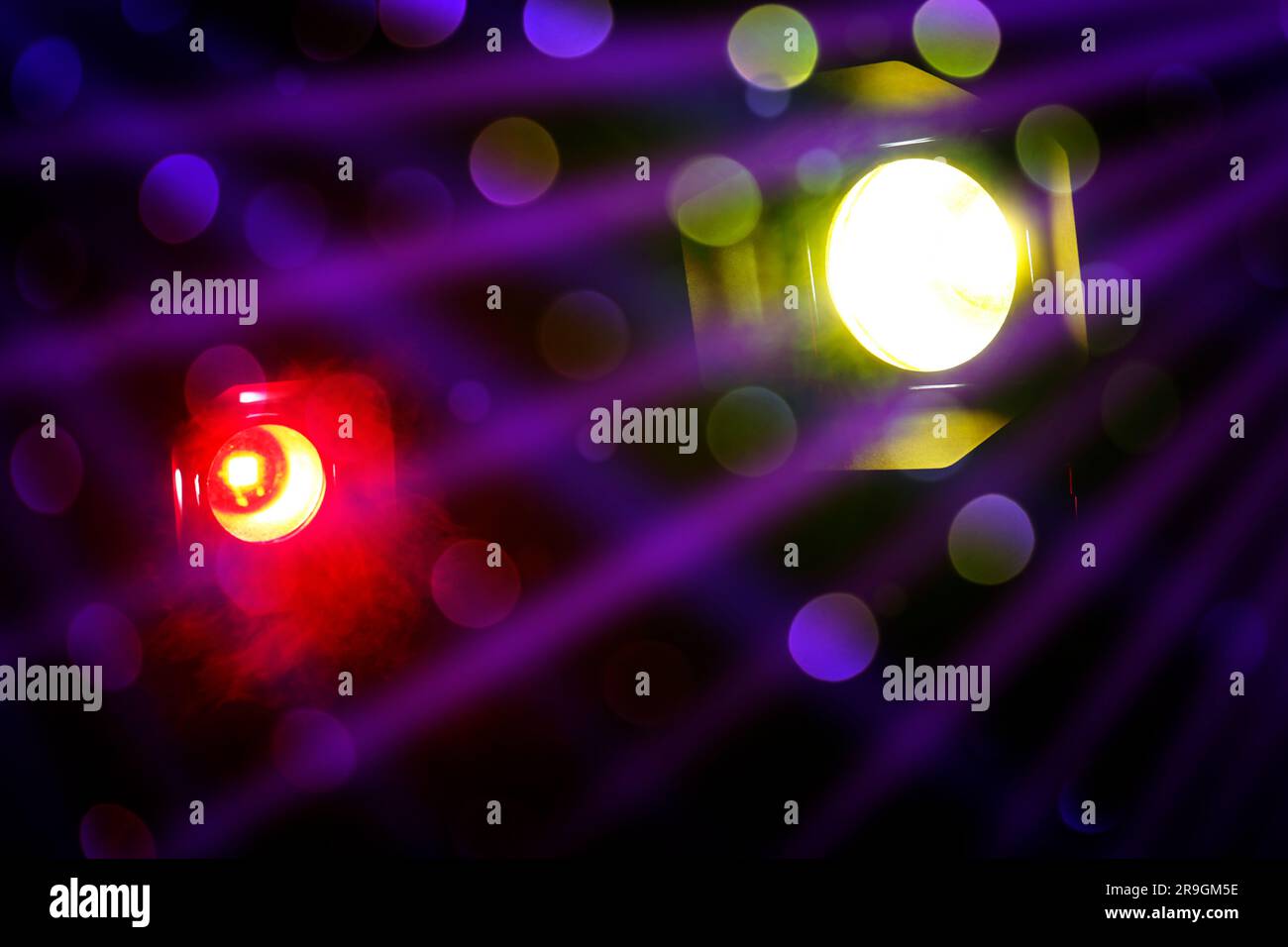 Bright spotlights and beams of light in night club, bokeh effect Stock ...