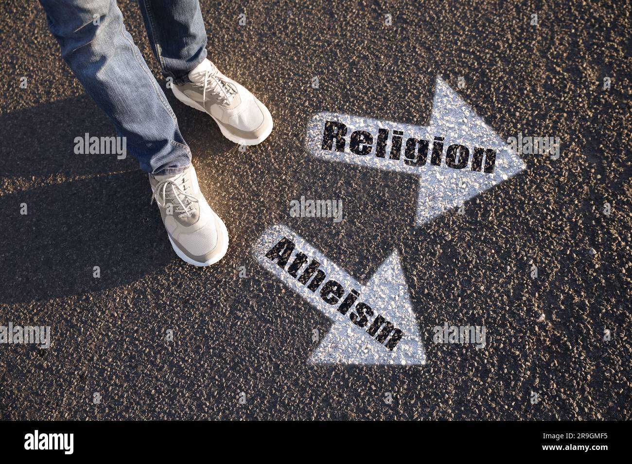 Choice between atheism and religion. Man standing near drawn marks on ...