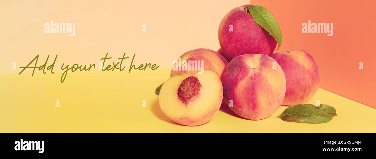 Fresh ripe peaches with green leaves on color background. Add your text ...