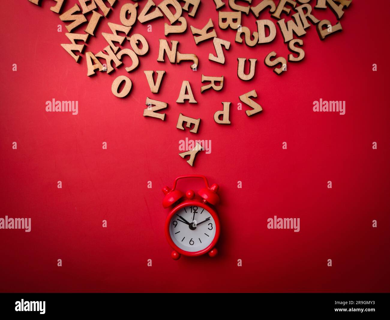 Top view red alarm clock and wooden word on a red background Stock ...