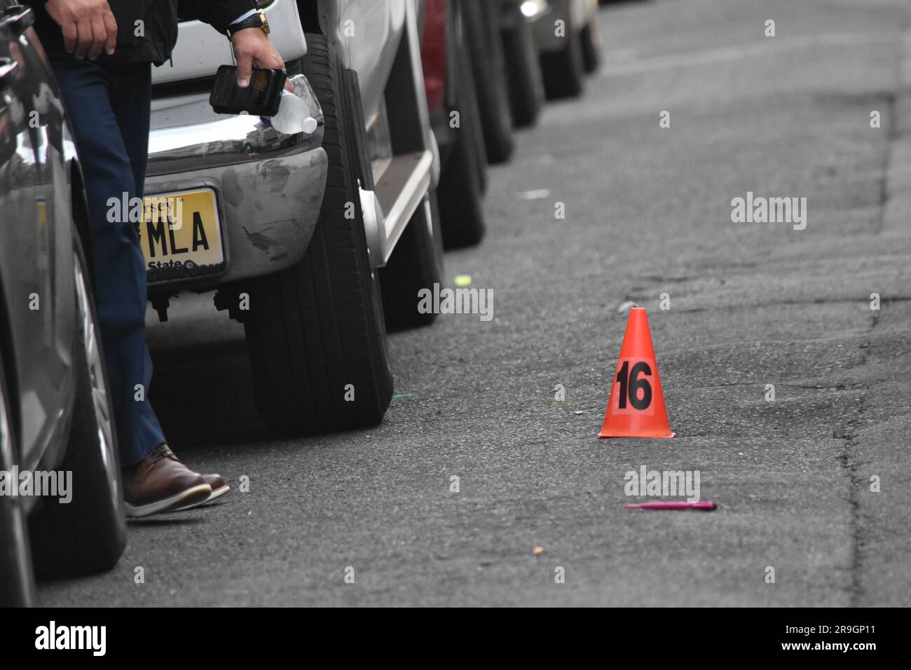 Police officers search for clues and mark evidence located at the crime ...