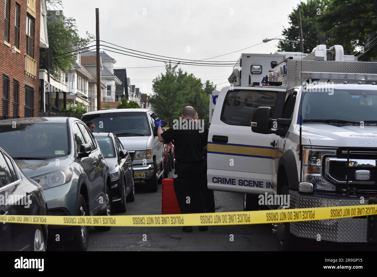 Police officers search for clues and mark evidence located at the crime ...