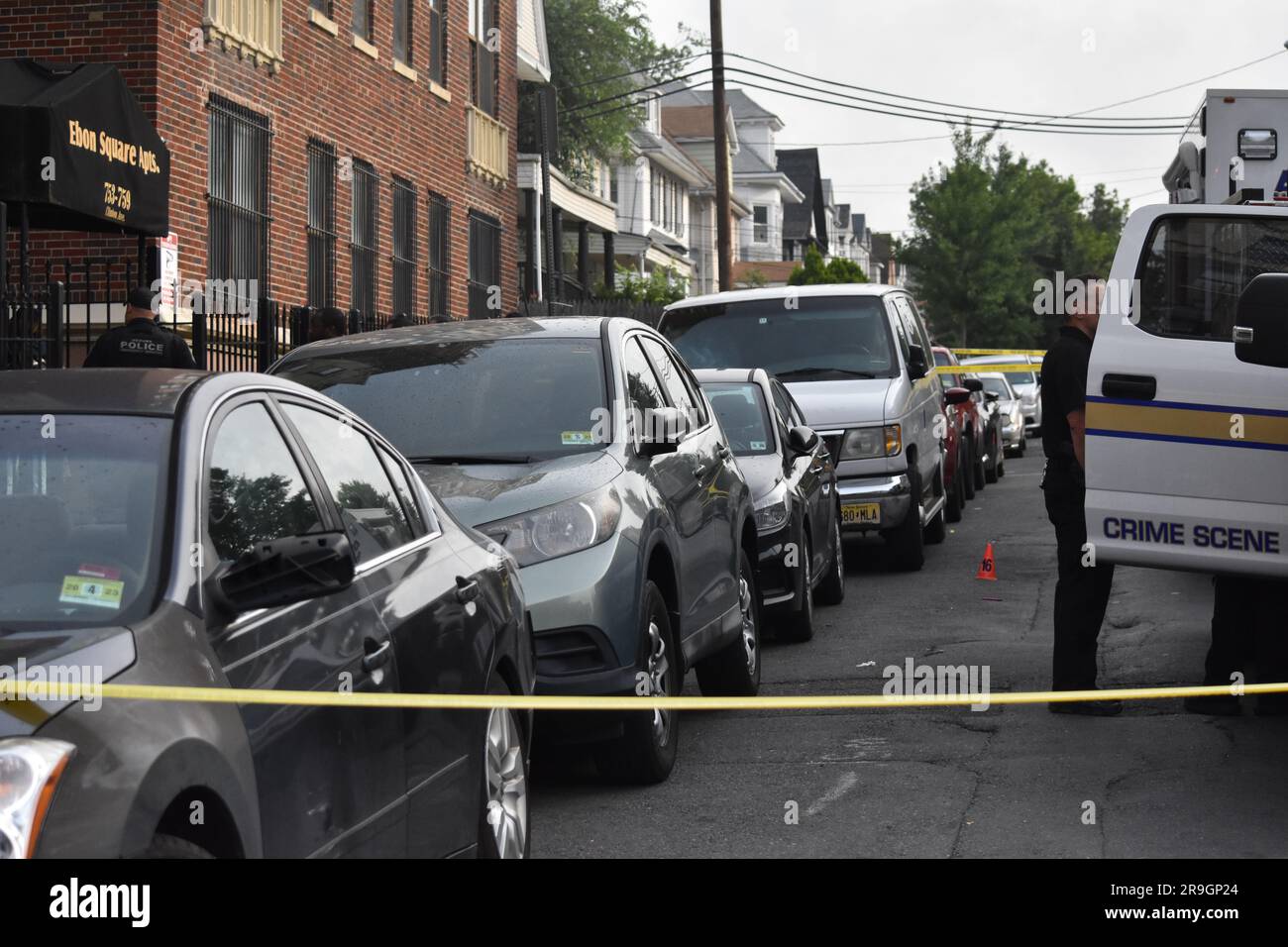 Police officers search for clues and mark evidence located at the crime ...