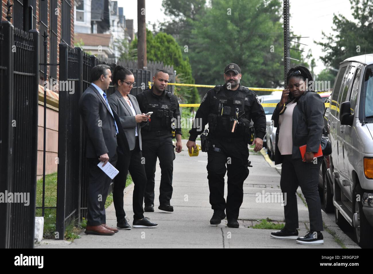 Police officers search for clues and mark evidence located at the crime ...