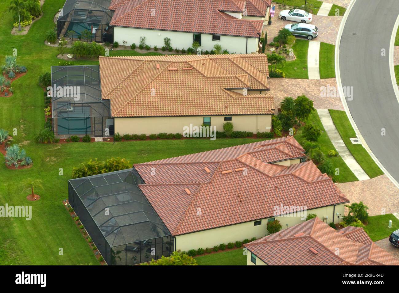 Aerial view of expensive modern houses with outside swimming pool ...