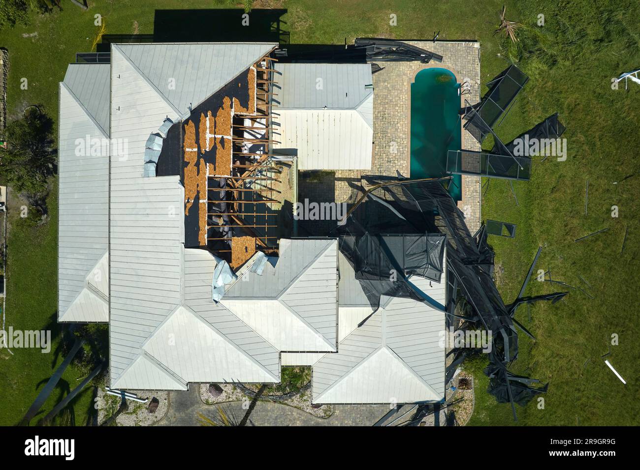 Hurricane Ian destroyed house roof in Florida residential area. Natural ...
