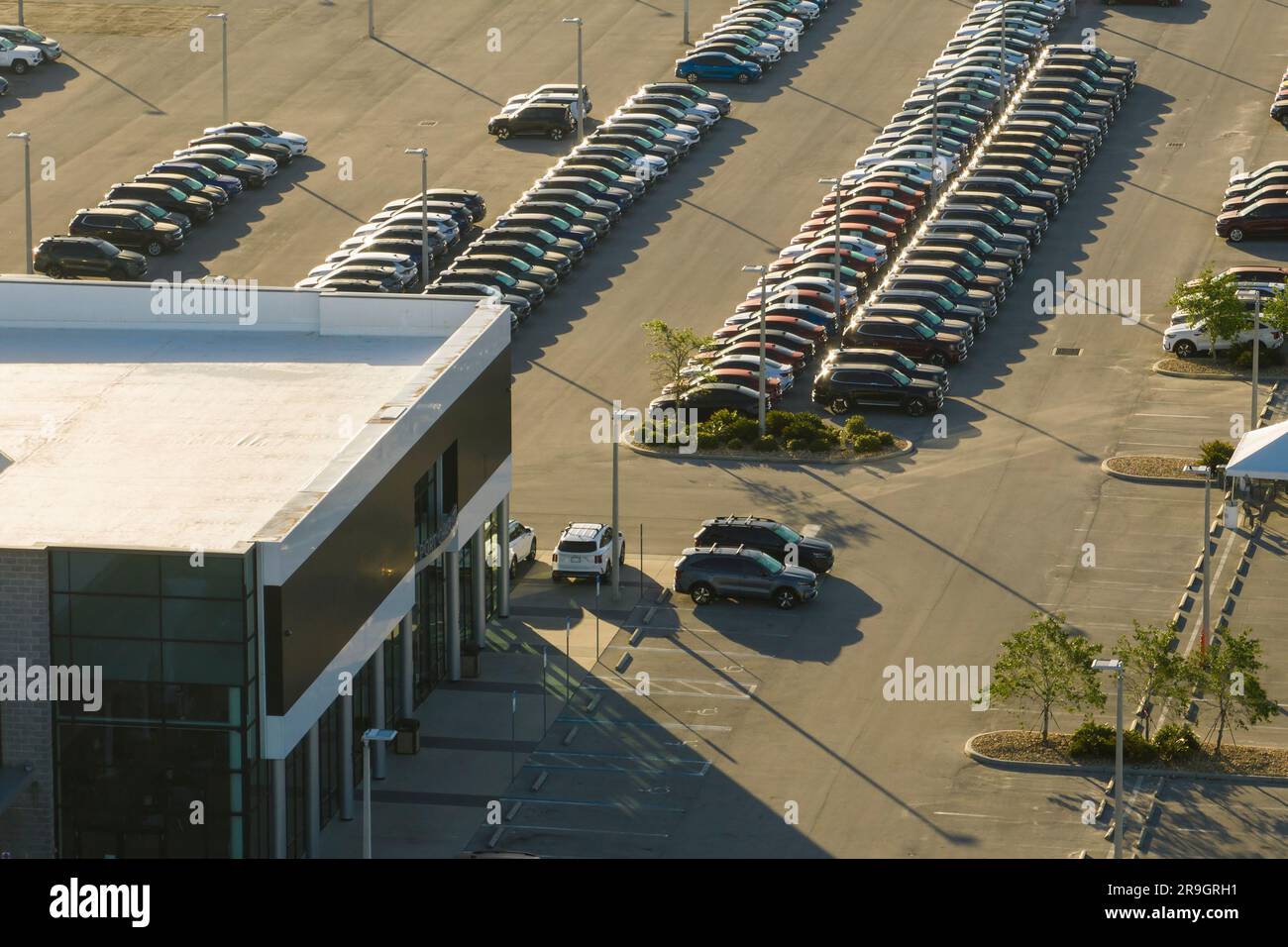 View from above of dealers outdoor parking lot with many brand new cars ...
