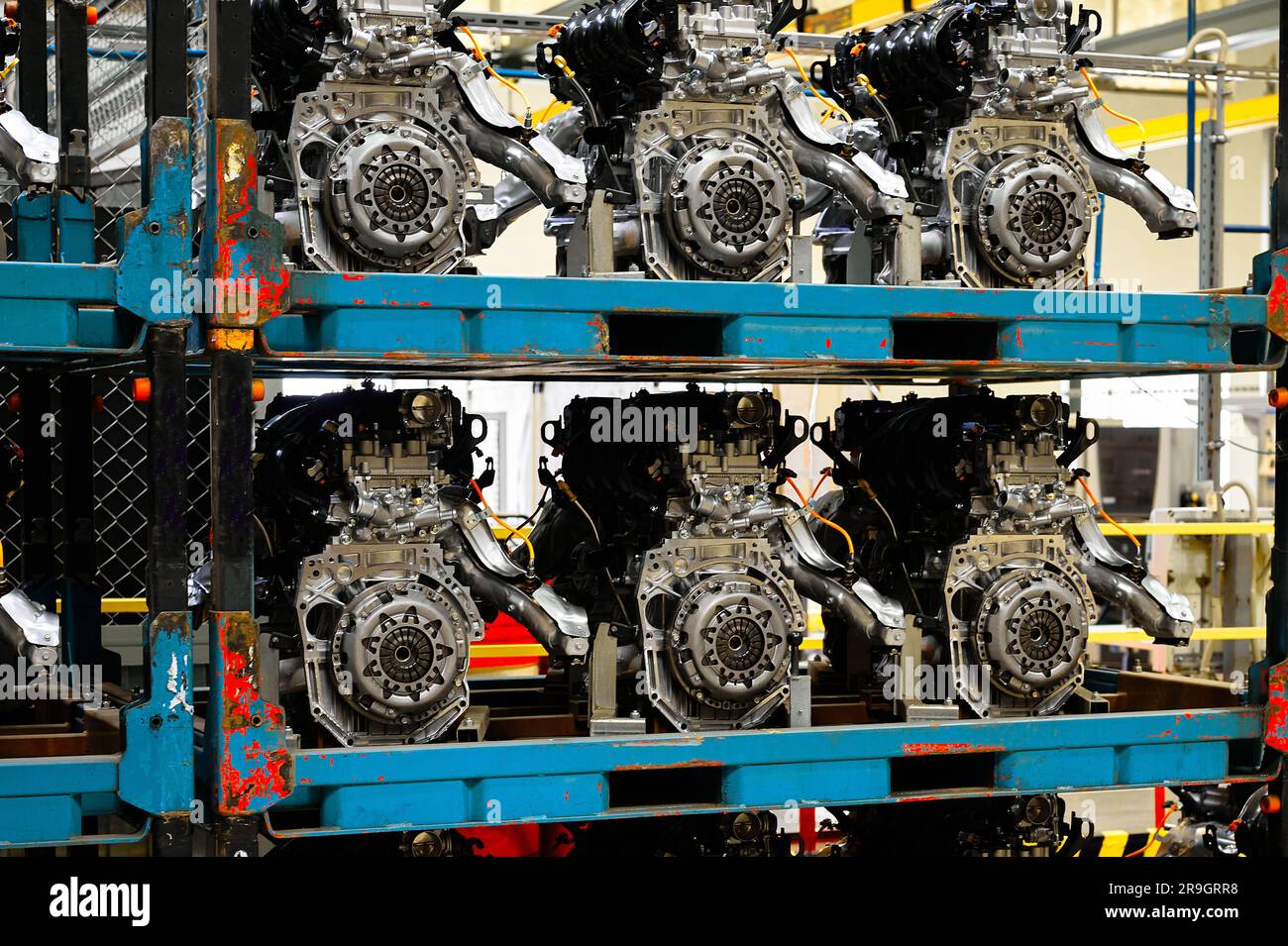 Car internal combustion engines stand on racks in warehouse Stock Photo ...