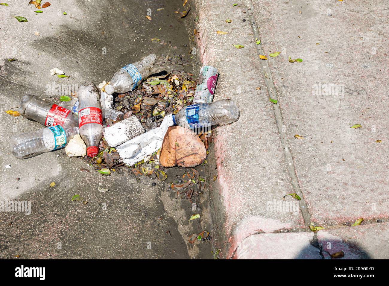 Miami Beach Florida,curb sidewalk street trash litter,plastic bottles ...