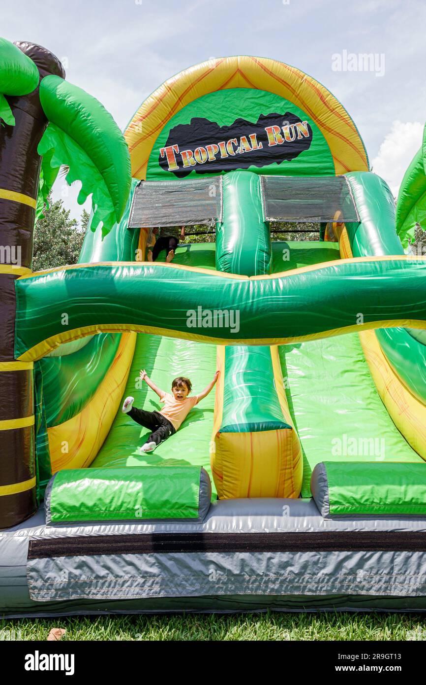 Inflatable slide boy sliding down fun hi-res stock photography and ...